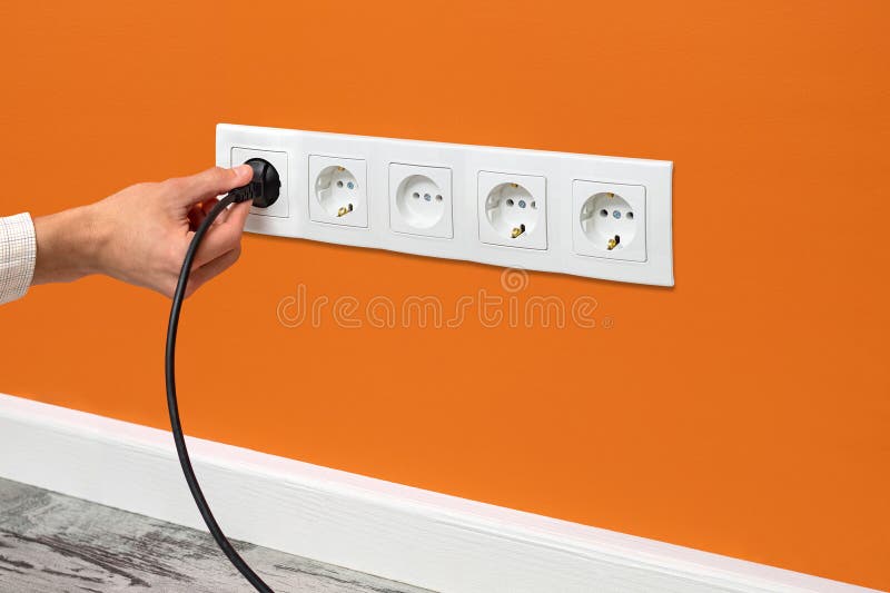 Man Plugging Cord into a Electrical Outlet Stock Image - Image of ...