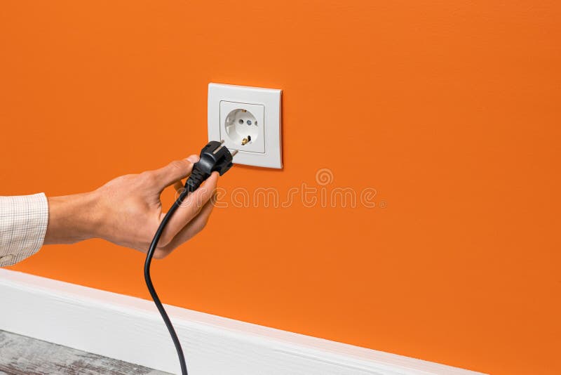 Man Plugging Cord into a Electrical Outlet Stock Image - Image of ...