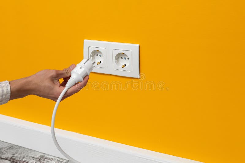 Man Plugging Cord into a Electrical Outlet Stock Image - Image of ...
