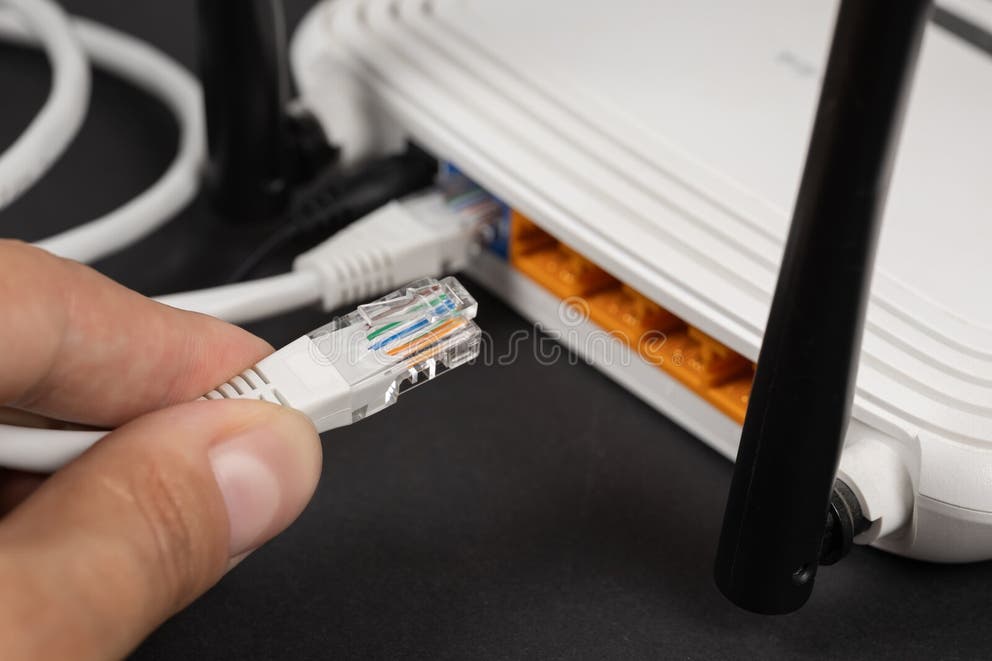 Man Plugging Internet Cable into Wi-fi Router Stock Photo - Image of ...