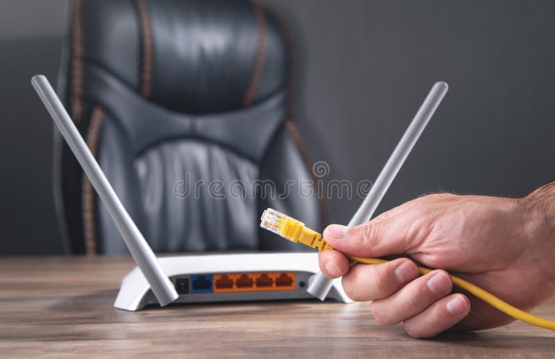 Man Plugging Internet Cable into Wifi Router Stock Image - Image of ...
