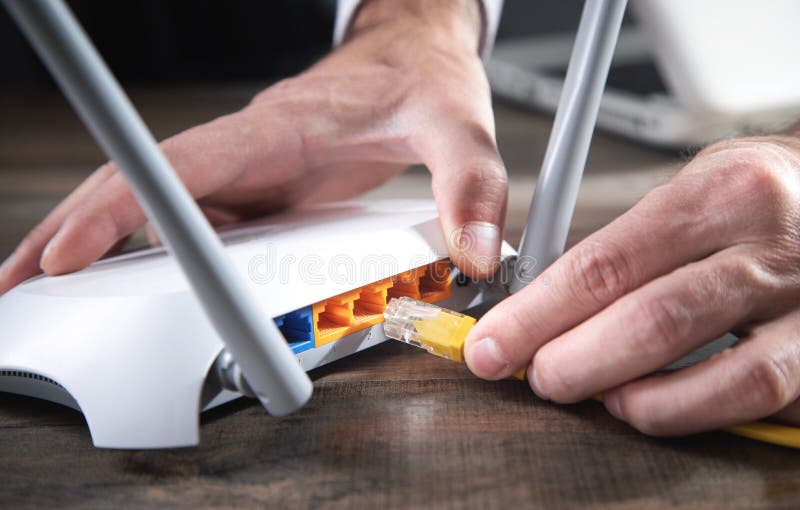 Man Plugging Internet Cable into Wifi Router Stock Image - Image of ...