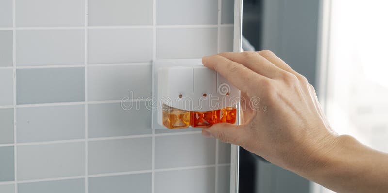 Man Plugging a Plug-in Air Freshener Stock Photo - Image of electric ...