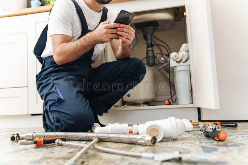 Man Plumber Work in Uniform Indoors Using Mobile Phone Stock Photo ...