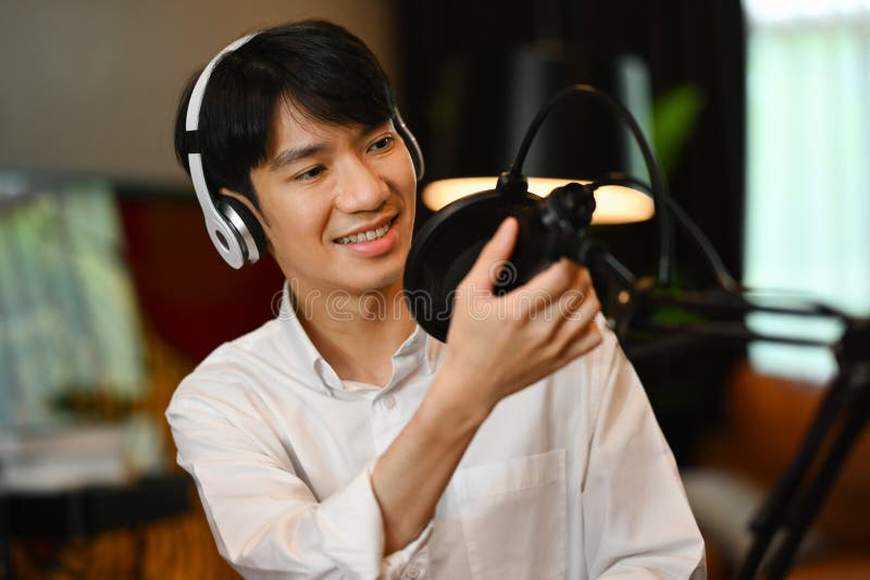 Man Podcaster Wearing Headphone Talking into a Microphone while Making ...