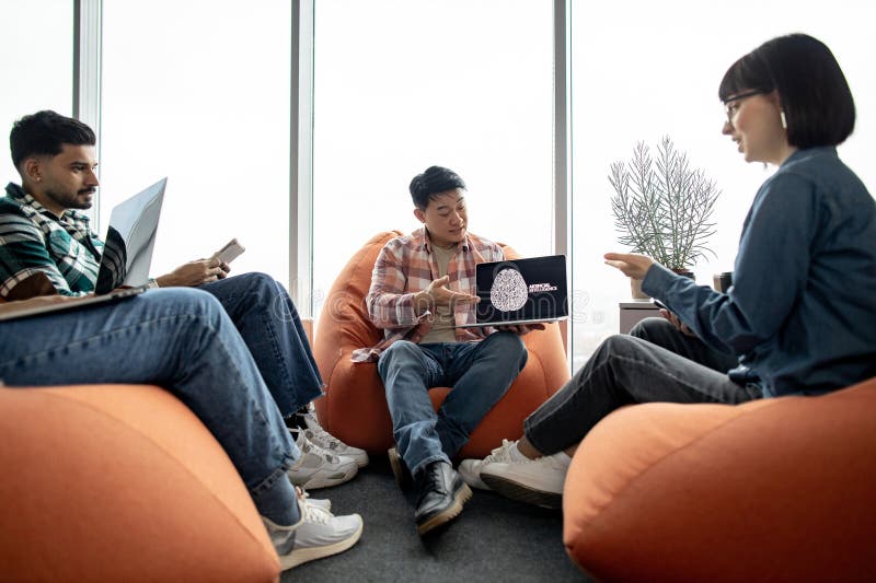 Man Pointing at AI Image while Mates Chatting at Workplace Stock Image ...