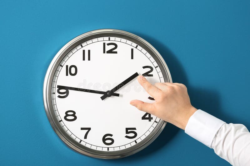 Man Pointing on Clock Against Color Background. Time Management Concept ...