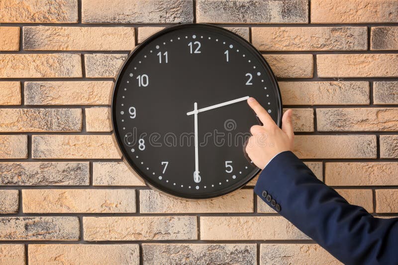 Man Pointing on Clock Against Wall Background. Time Management Concept ...
