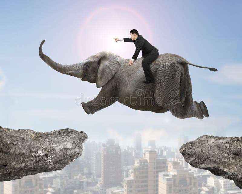 Man with Pointing Finger Riding Elephant Flying Over Two Cliffs Stock ...