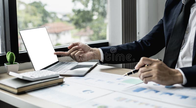 A Business Man is Checking Company Financial Documents and Using a ...