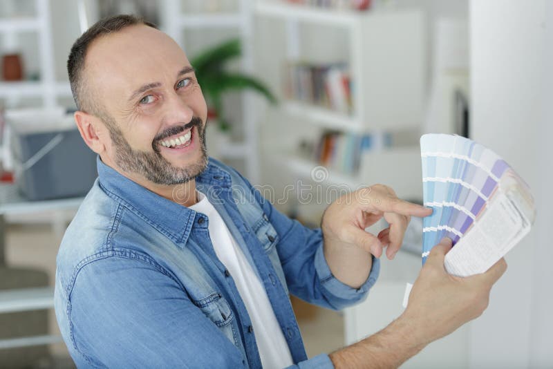 Man Pointing Towards Paint Colour Sample and Laughing Stock Image ...