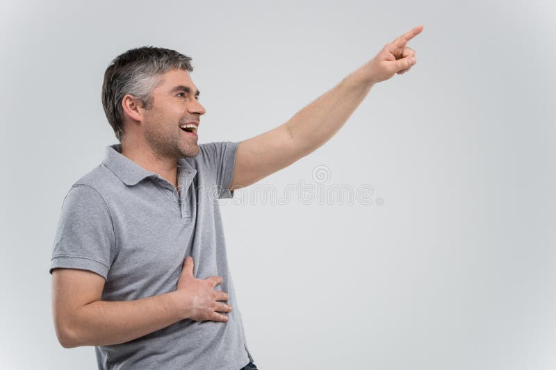 Man Pointing Up and Laughing on Grey Background. Stock Image - Image of ...