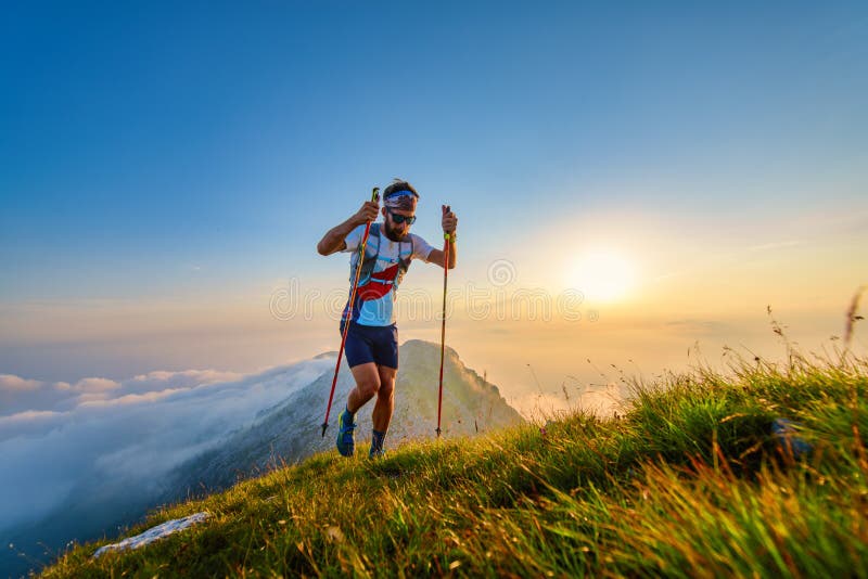 Man with Poles in the Mountains with Sunset Behind Stock Image - Image ...