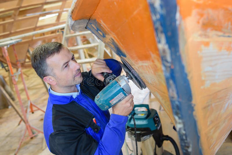 Man polishing boat stock image. Image of overalls, float - 186439411