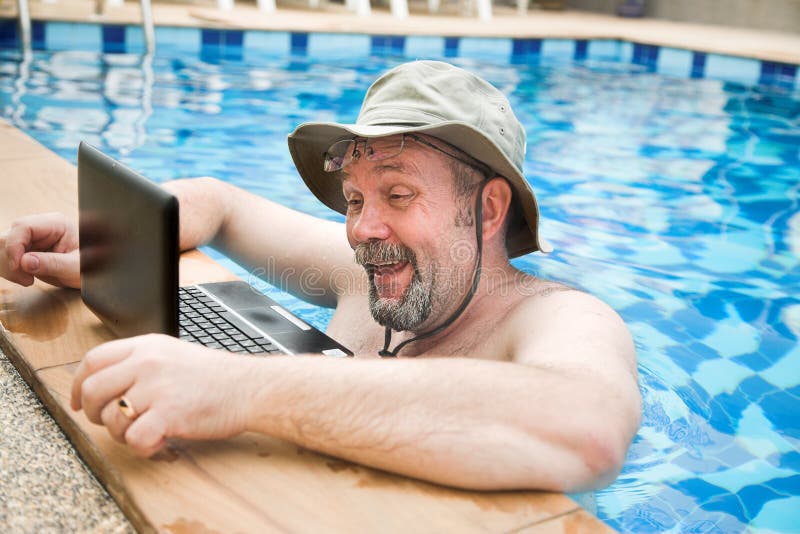 Man Working on Laptop at the Swimming Pool Edge. Top Down Viewpoint ...
