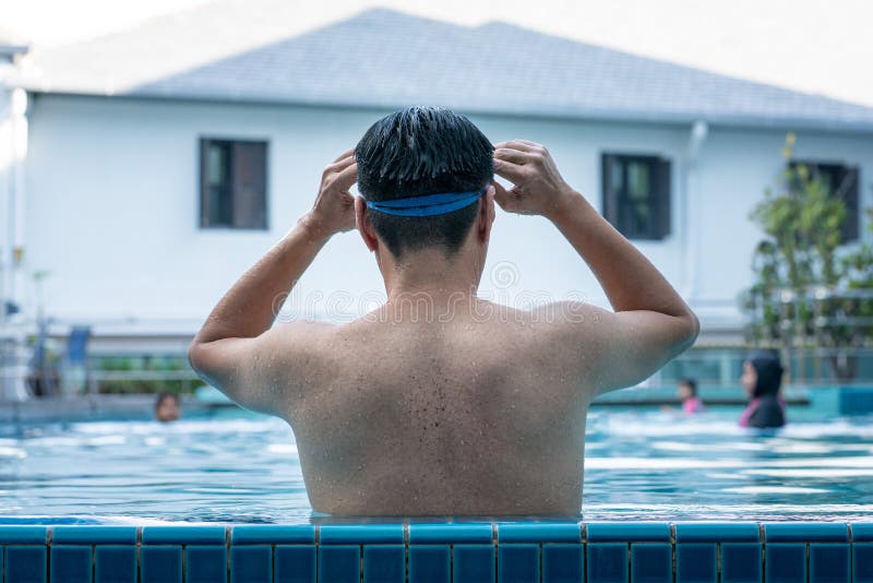 Man in the Pool, Relaxing and Adjusting His Goggles. on Vacation ...