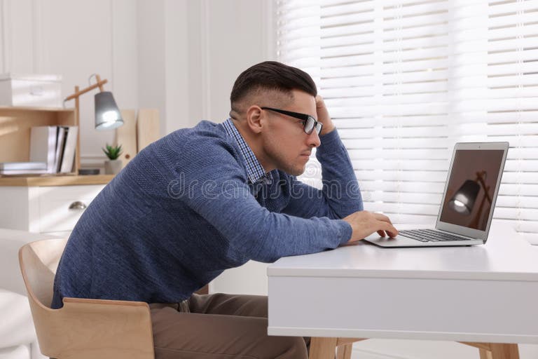 Man with Poor Posture Using Laptop at Table Indoors Stock Photo - Image ...