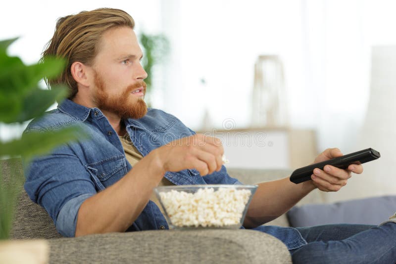 Man with Popcorn and Remote Control Looks at Tv Stock Image - Image of ...