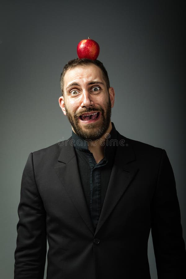 Man Portrait in Gray Background with Apple on Head Stock Photo - Image ...