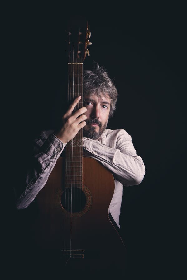 Man Poses with His Guitar in a Studio Photograph Stock Photo - Image of ...