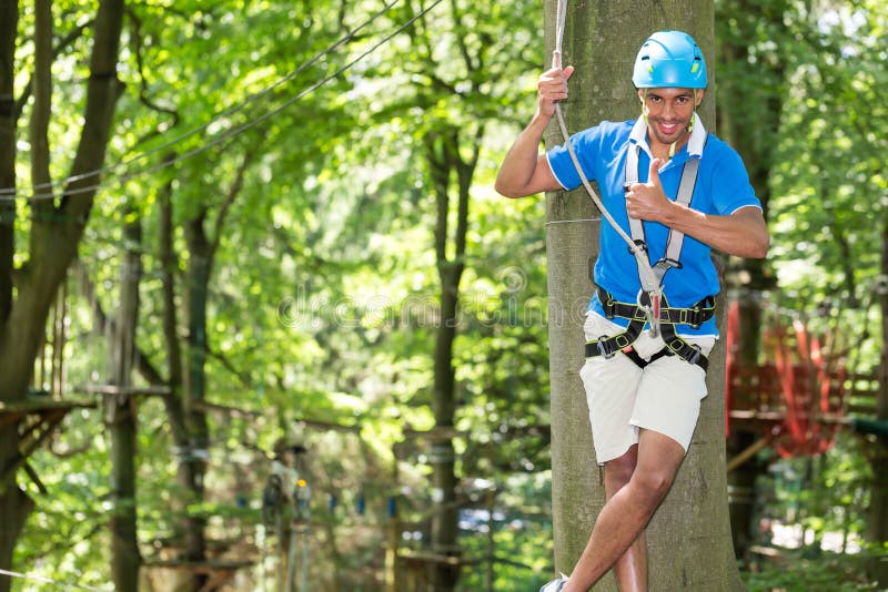 Man Poses on Platform at High Rop Course Stock Image - Image of outdoor ...
