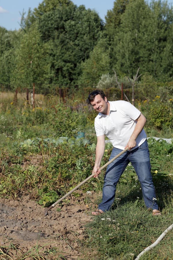 Man poses with rake stock photo. Image of concentrated - 20684522