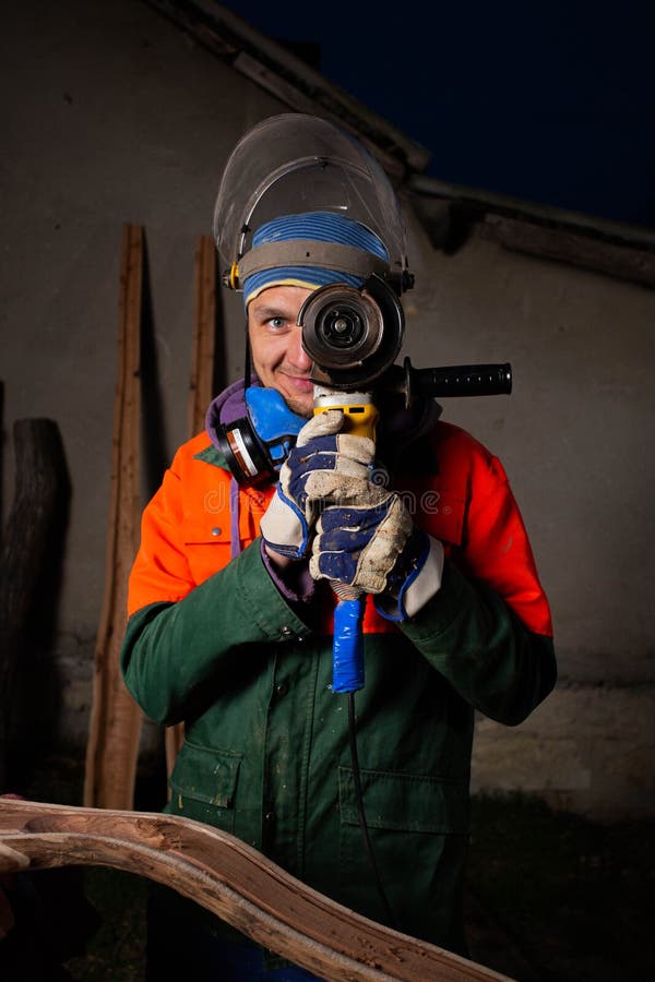 A Man Poses with a Tool while Working on Wood. the Process of Making ...