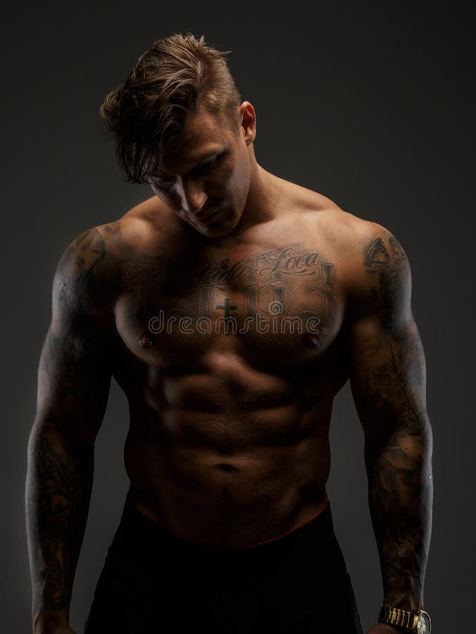 Muscular guy looking down stock image. Image of hairstyle - 108259215