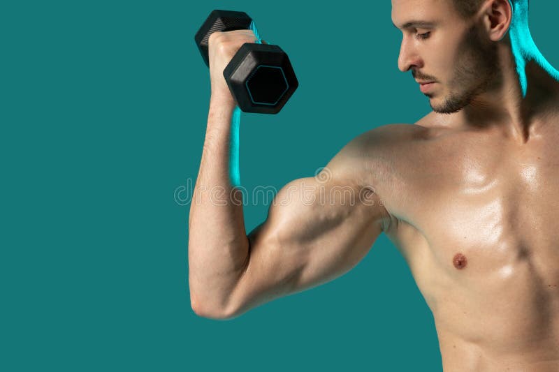Man Posing with Dumbbells on Blue Background, Showing His Biceps Stock ...