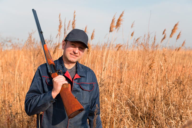 Man posing with a gun stock image. Image of rifle, activity - 65324711