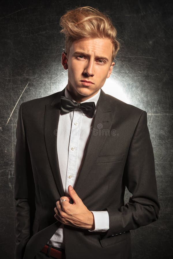 Man Posing with Hand in Pocket while Fixing His Jacket Stock Photo ...