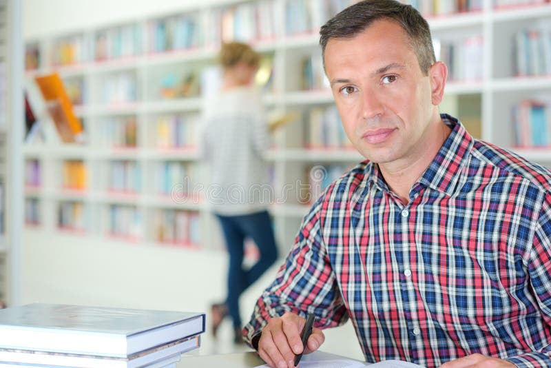 Man posing in library stock photo. Image of public, profit - 89548574