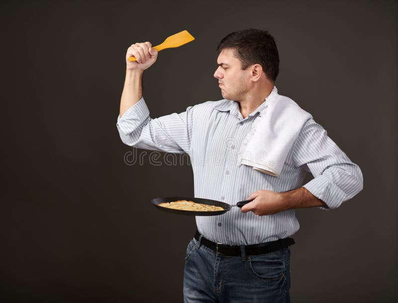 Man Posing with a Pancake in a Pan, White Shirt and Pants, Gray ...
