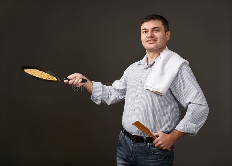 Man Posing with a Pancake in a Pan, White Shirt and Pants, Gray ...