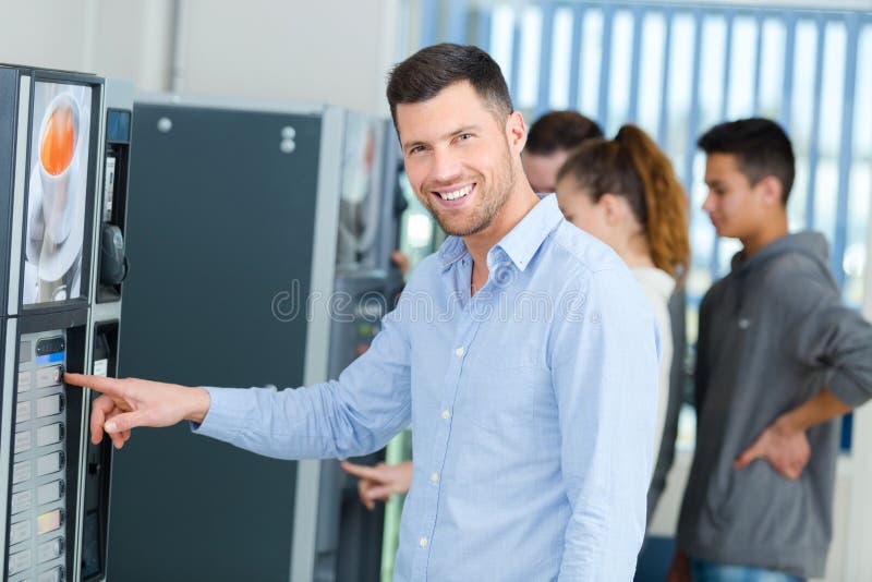 Man Posing while Pressing Vending Machine Stock Photo - Image of ...