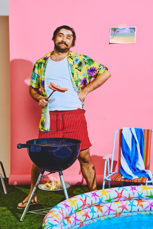 Man Posing in Studio with Inflatable Pool and Cooking Barbeque Sausages ...