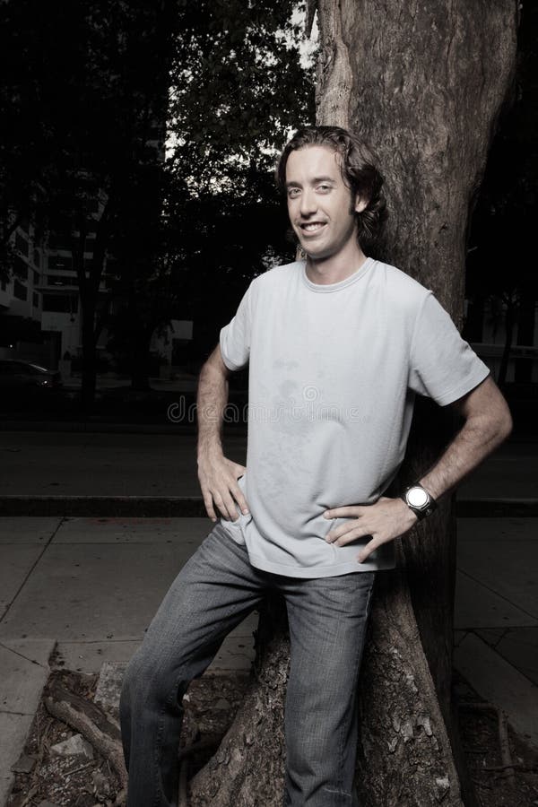 Man posing by a tree stock photo. Image of joyous, happy - 10582756