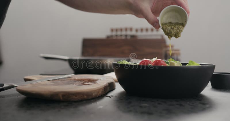 Man Pour Dressing on Salad on Kitchen Countertop Stock Photo - Image of ...