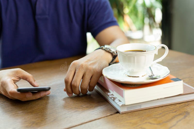Man Pouring Coffee into a Cup with Laptop on the Table. Stock Image ...