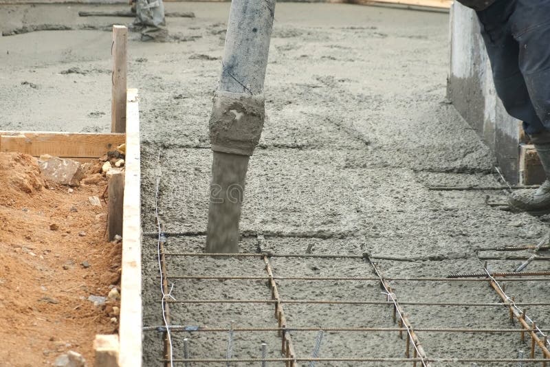 Man is Pouring Foundation with Wet Heavy Concrete through Pipe, Closeup ...
