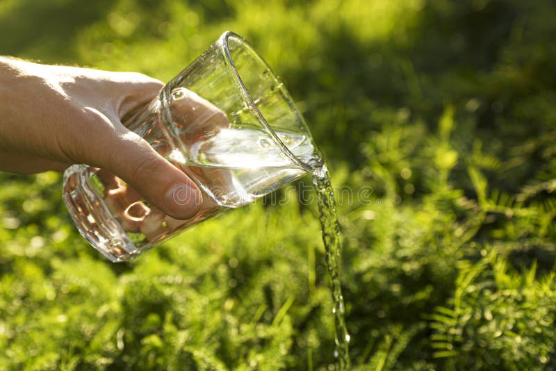 Man Pouring Fresh Water from Glass Outdoors, Closeup Stock Image ...