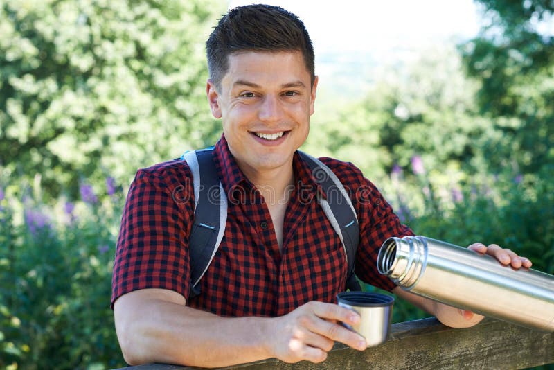 Portrait of Man Pouring Hot Drink from Flask on Walk Stock Photo ...