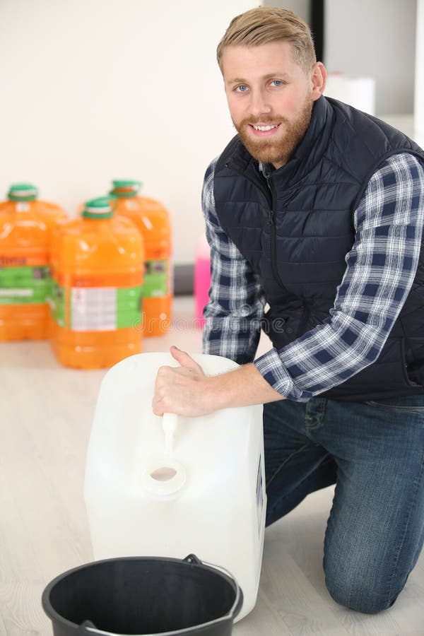 Man Pouring Industrial Chemical into Bucket Stock Image - Image of ...