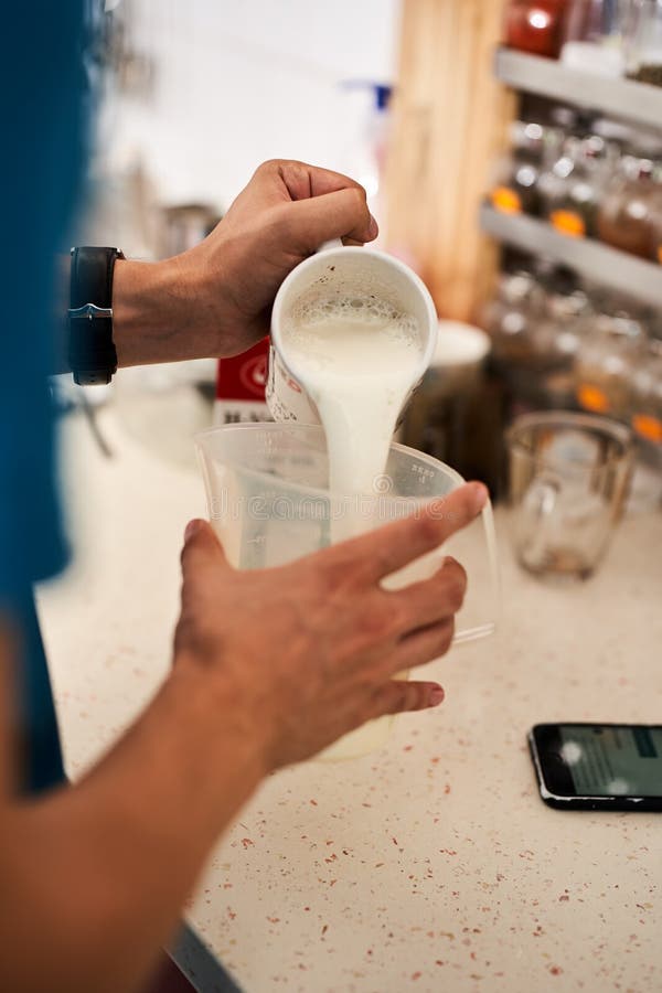 Man`s hands pouring milk stock photo. Image of preparation - 156501072