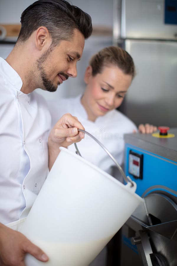 Man Pouring Something on Machine in Factory Stock Photo - Image of hair ...