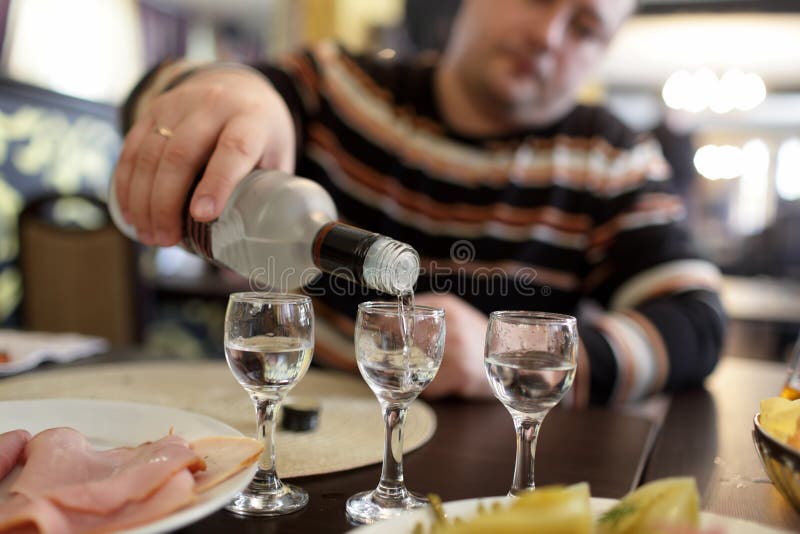Man pouring vodka in pub stock photo. Image of alcohol - 30096062