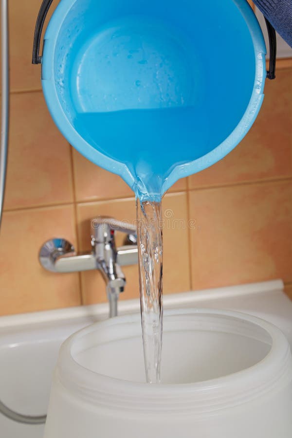 Man Pouring Water from Bucket into Plastic Barrel Stock Image - Image ...