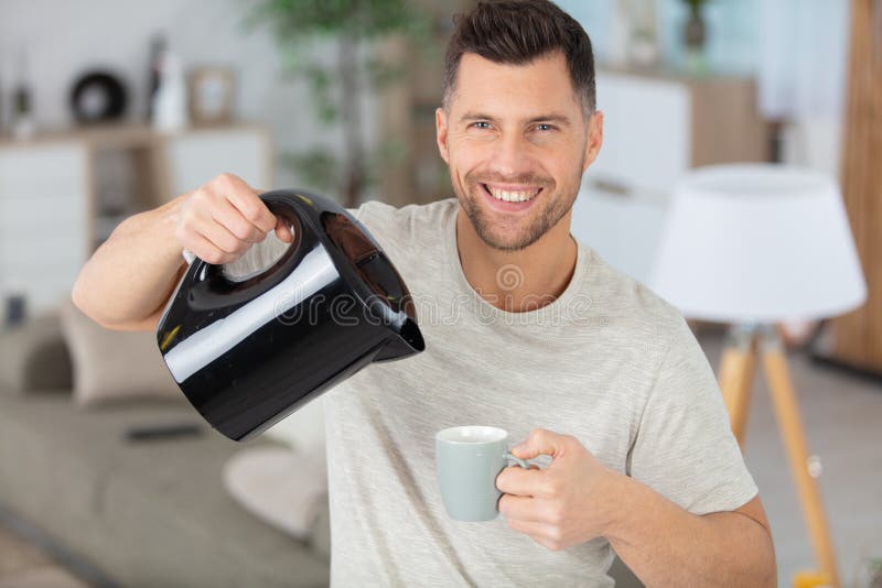 Man Pouring Water from Electric Kettle Stock Image - Image of lifestyle ...