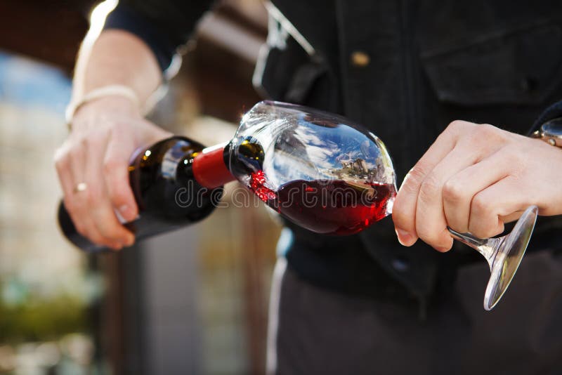 Man Pouring Wine into Wineglass, Male Hand Holding Bottle Stock Image ... Man Pouring Wine into Wineglass, Male Hand Holding Bottle Stock Image ...