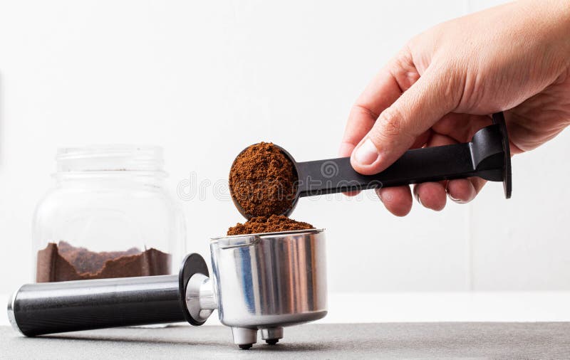 A Man Pours Coffee from a Measuring Spoon into a Coffee Maker S Horn on ...